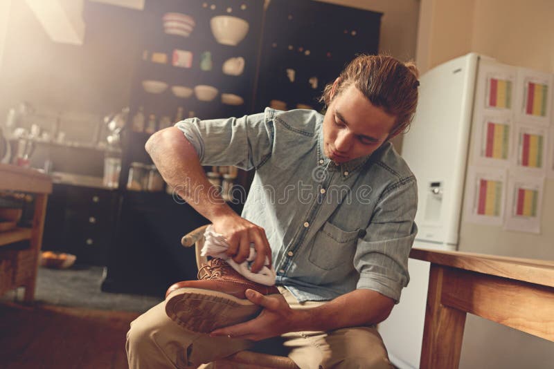 Keeping His Shoes Clean. a Handsome Young Man Cleaning His Shoes in the ...