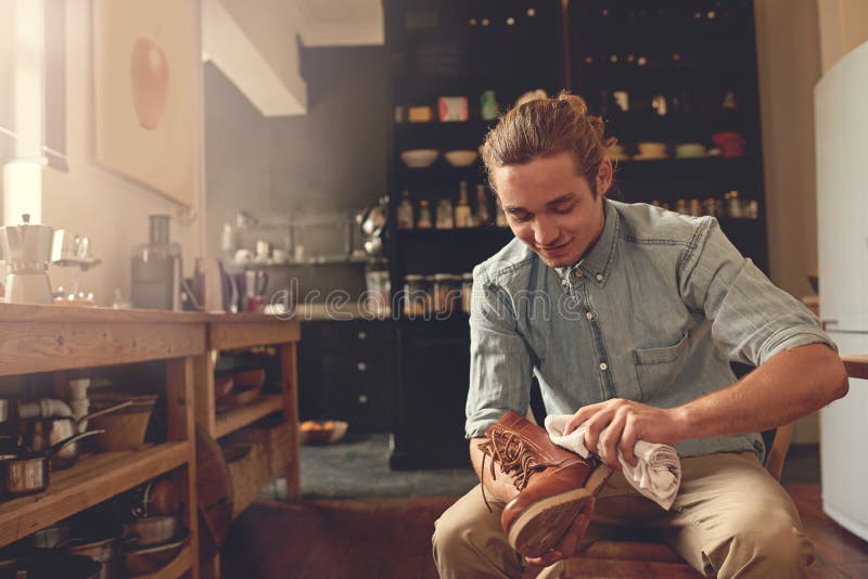 Keeping His Shoes Clean. a Handsome Young Man Cleaning His Shoes in the ...