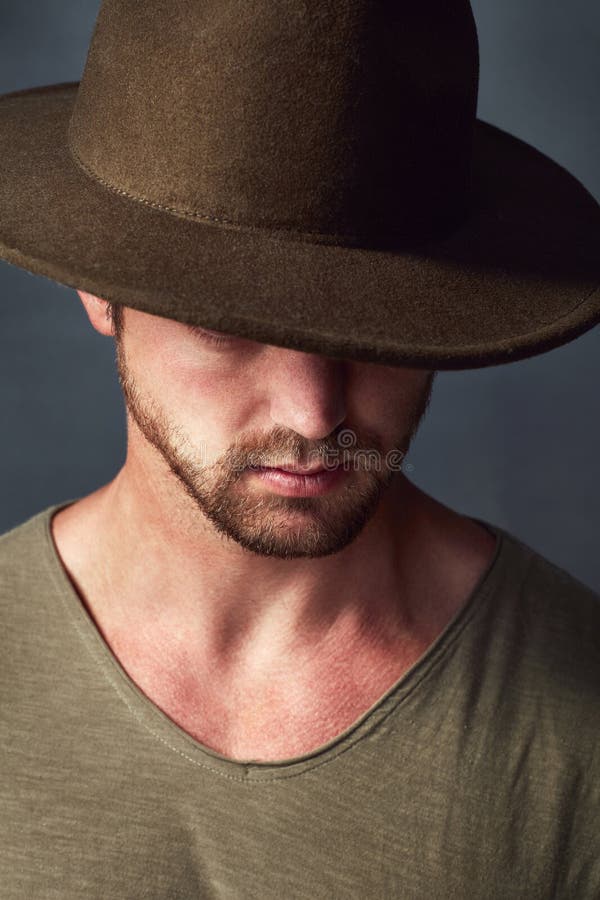 Keeping it Low Key. Studio Shot of a Handsome Young Man Posing Against ...