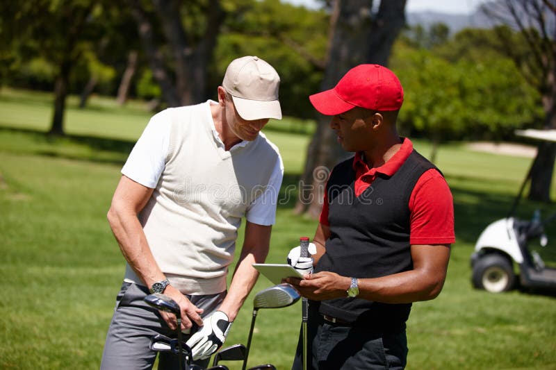 Keeping Score on His Tablet. Two Handsome Men Enjoying a Day on the ...