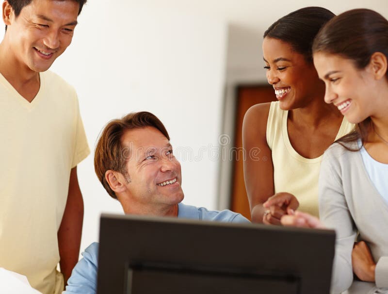 Keeping Them Motivated. a Work Team Gathered Around a Computer. Stock ...