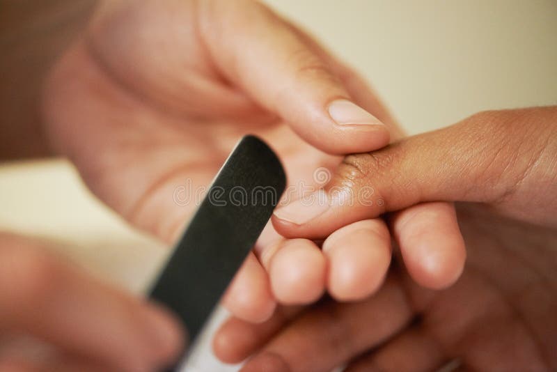 Keeping the Tools Sharpened. a Woman Getting Her Nails Filed. Stock ...