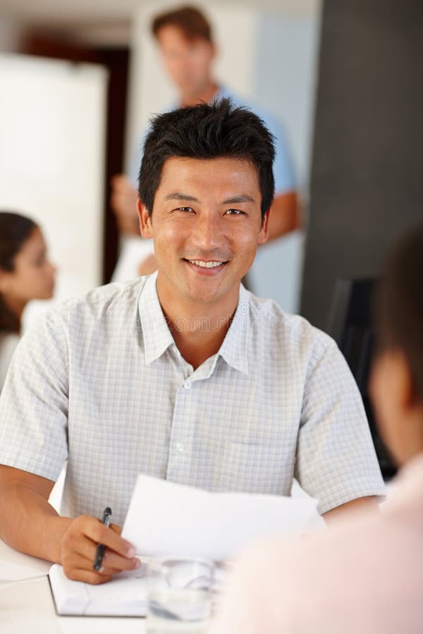 Keeping Track and Taking Notes. Portrait of a Smiling Asian Man Sitting ...