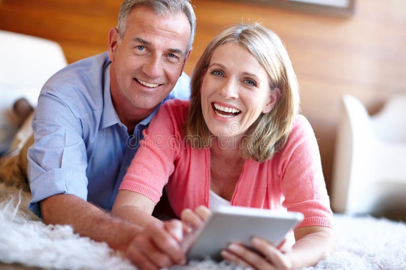 Keeping Up with Modern Technology. a Loving Husband and Wife Using a ...