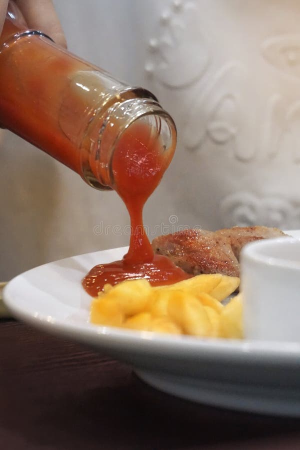 Ketchup Flow from the Bottle Onto a Plate of Steak and Fried Pot Stock ...