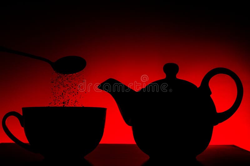 Kettle with a Cup in Red Light, Sugar Poured from Spoon into Cup Stock ...