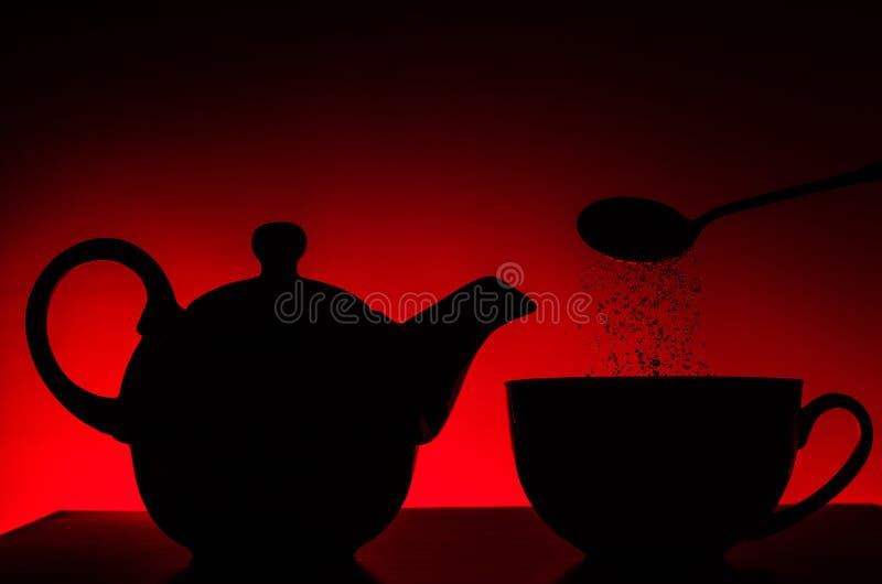 Kettle with a Cup in Red Light, Sugar Poured from Spoon into Cup Stock ...