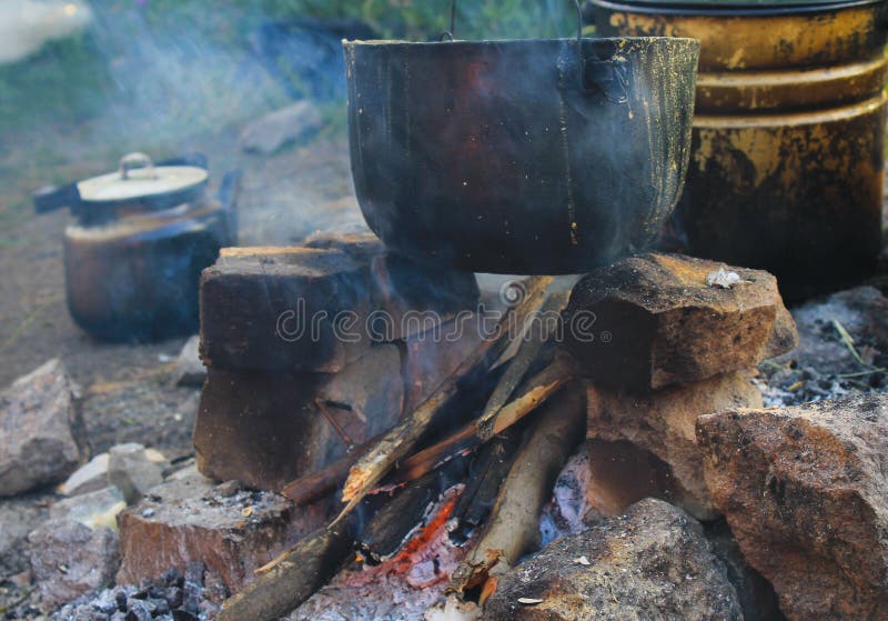 Kettle Over Burning Campfire Stock Image - Image of coal, lunch: 76610359