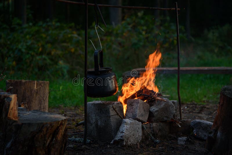 The Kettle Stands Over a Fire in the Forest. a Smoked Kettle Over the ...