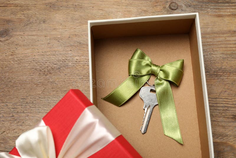 Key with Bow in Gift Box on Wooden Table, Top View. Housewarming Party ...
