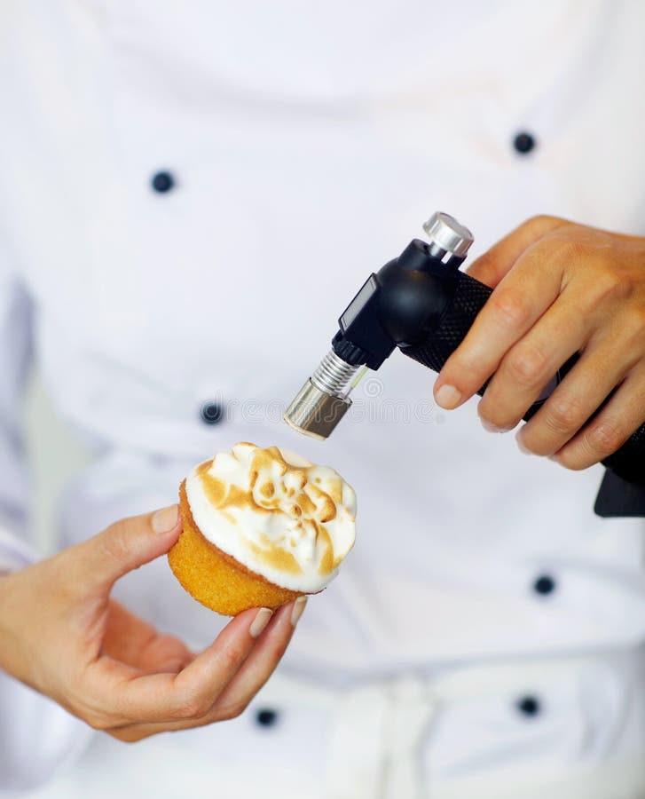 The Key is Caramelization. a Chef Using a Blowtorch To Brown Meringue ...