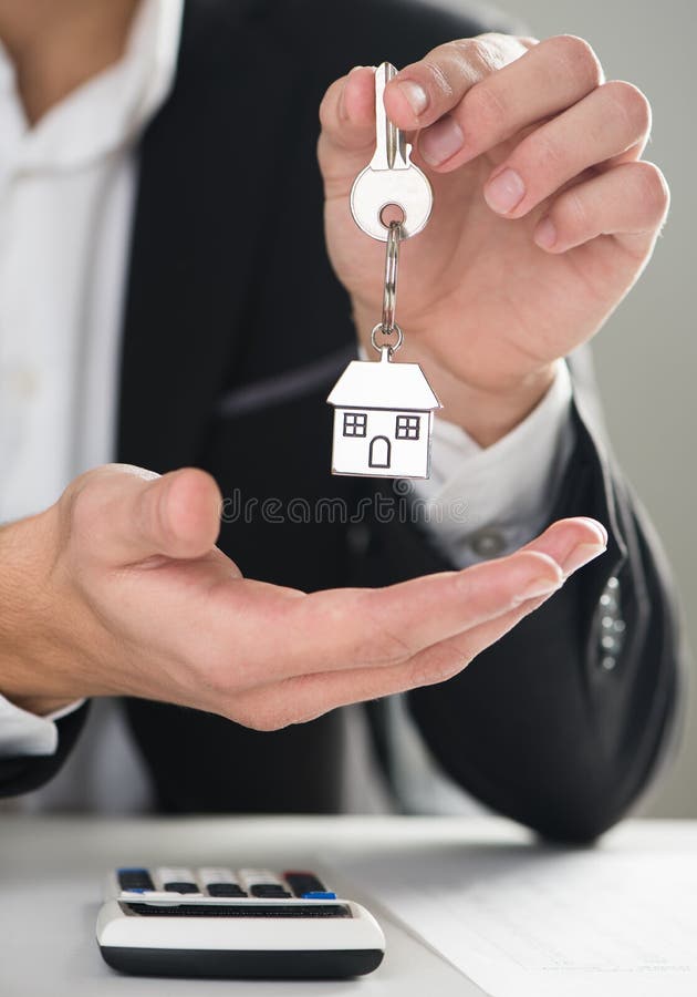 Key chain with key in hand stock photo. Image of male - 102158938