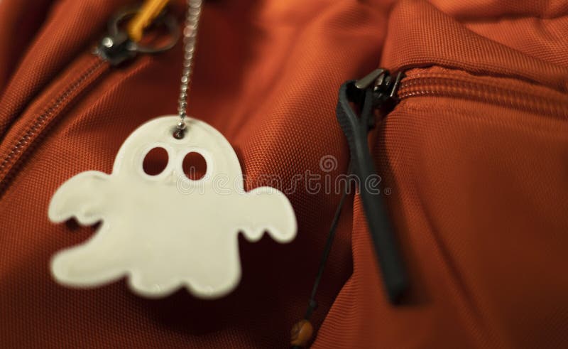 Key Chain Reflector in Ghost Pattern Form on Orange Backpack, Security ...