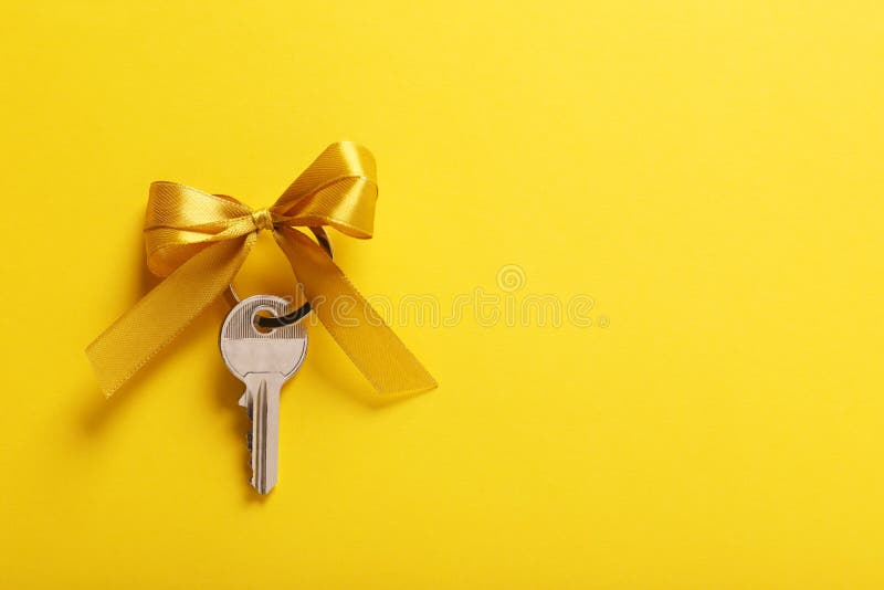 Key with Color Bow on Yellow Background, Top View. Space for Text ...