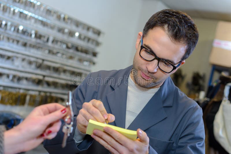 Key Cutter Taking Note Customer`s Order Stock Photo - Image of blue ...