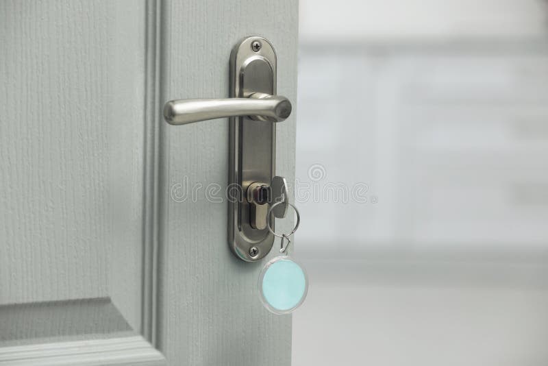 Key with Fob in Door Lock, Closeup. Space for Text Stock Photo - Image ...
