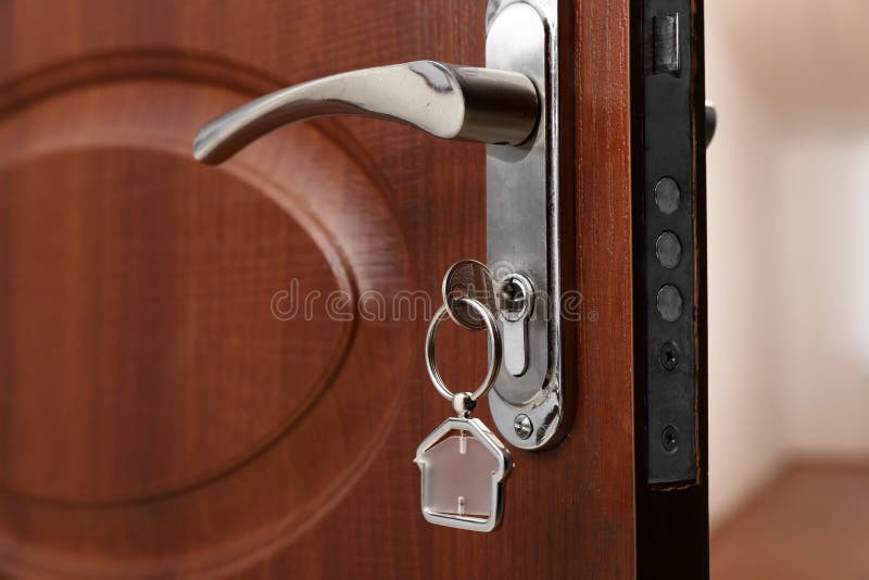 Key with House-shaped Trinket in Door Lock Stock Image - Image of ...