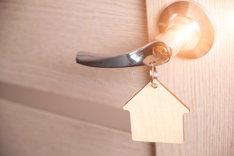 Key with Keychain in Form House in Door Lock.with Bright Sunlight Stock ...