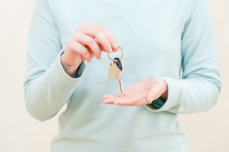 Key with Keychain in the Shape of the House in Hands Stock Image ...