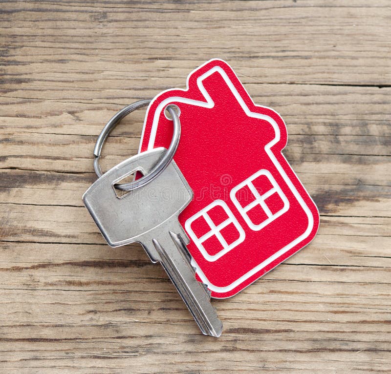 House Keys with Trinket in Female Hand on Color Background, Top View ...