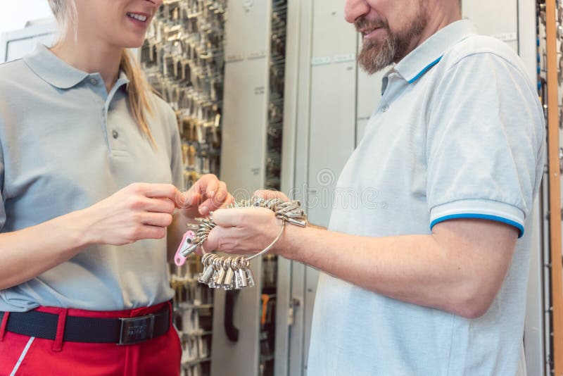 Locksmith in Workshop Makes New Key. Professional Making Key in ...