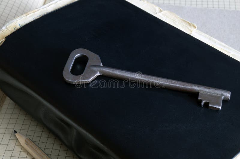 A Key and an Old Leather-bound Book Stock Photo - Image of battered ...