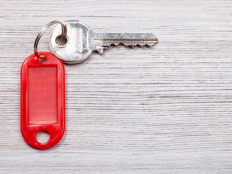 Key with Red Key Chain on Wooden Background Stock Image - Image of ...