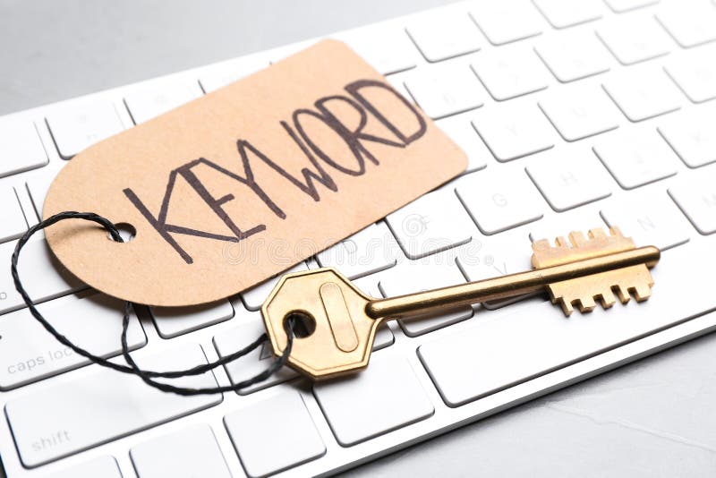 Key with Tag KEYWORD and Computer Keyboard on Table, Closeup Stock ...