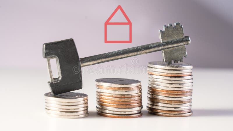 A Key is on Top of a Pile of Coins Stock Photo - Image of business ...