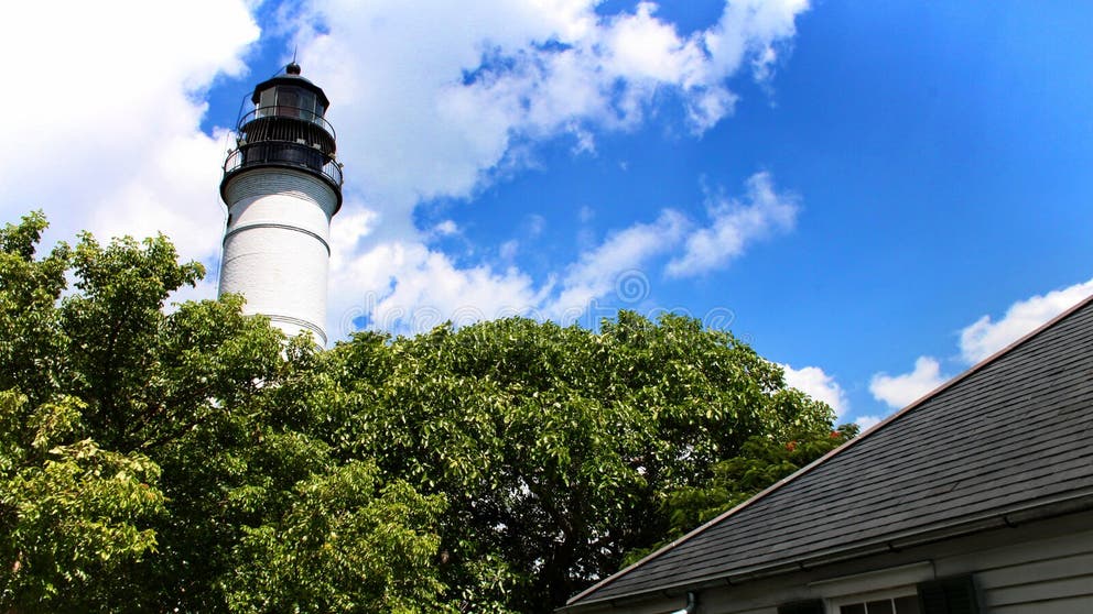 Key West Lighthouse on a Sunny Partly Cloudy Day Stock Photo - Image of ...