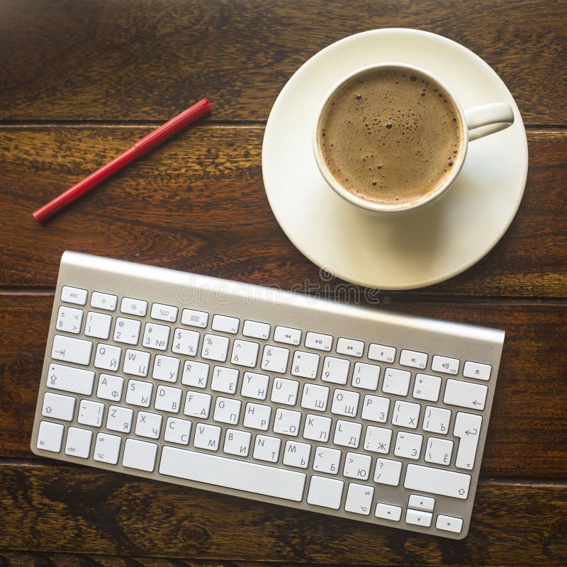 Top View of Keyboard, Pencil, Black Notebook and a Cup of Coffee on a ...