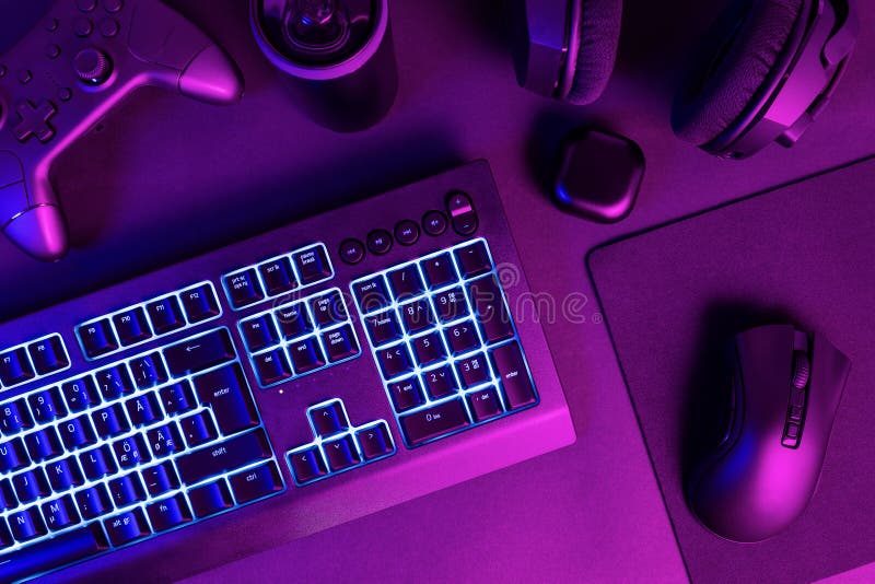 Blue Lit Keyboard Amidst Various Modern Devices Stock Image - Image of ...