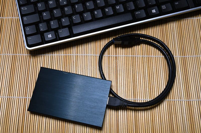 Keyboard and Portable USB Hard Disk Drive on Wood Background Editorial ...