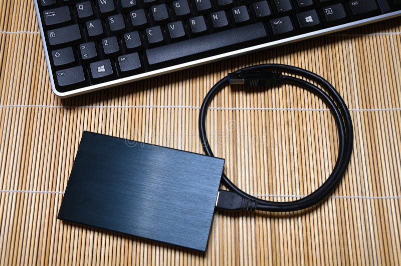 Keyboard and Portable USB Hard Disk Drive on Wood Background Editorial ...