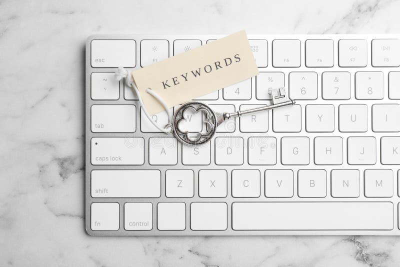 Keyboard, Vintage Key and Tag with Word KEYWORDS on White Marble Table ...
