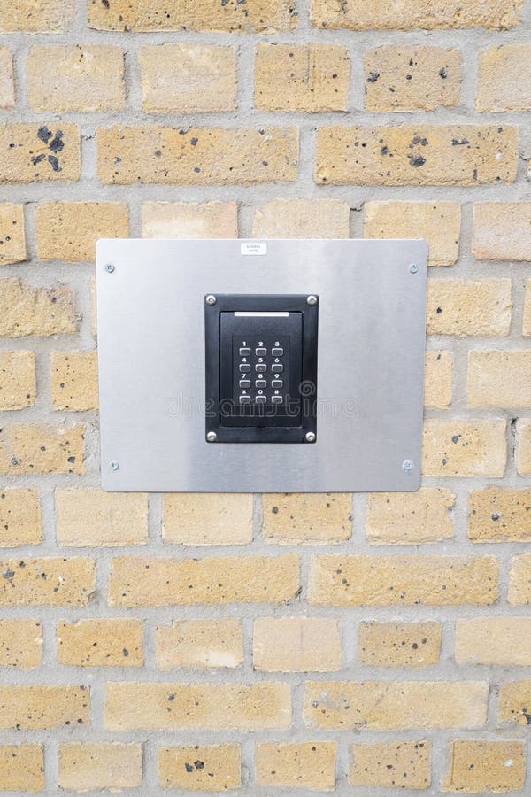 Keypad on a brick wall stock image. Image of yellow, electric - 90589963