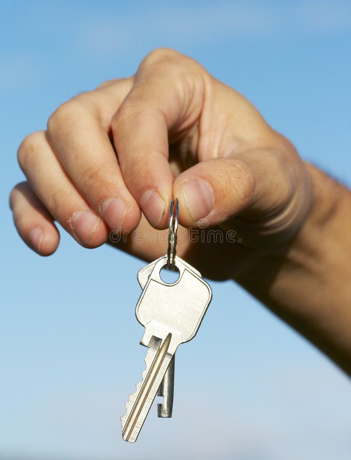 Keys on hand at blue skies stock image. Image of start - 7162529