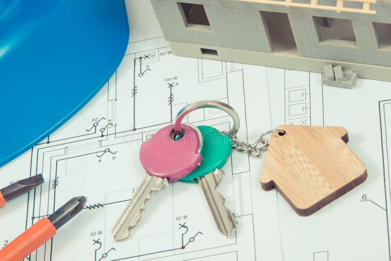 Keys with Home Shape and Small House Under Construction with Electrical ...