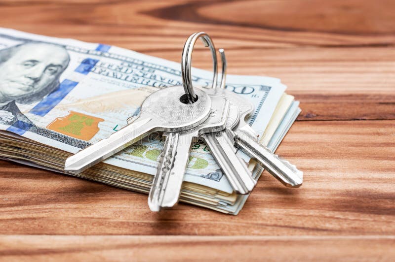 Keys with Stack of Dollar Bills on Wooden Table Stock Image - Image of ...