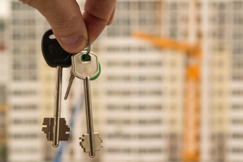 The Keys To the Apartment in Hand on the Background of Houses Stock ...