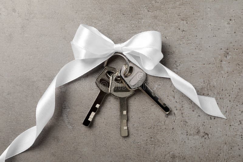 Keys with White Bow on Grey Table, Top View. Housewarming Party Stock ...