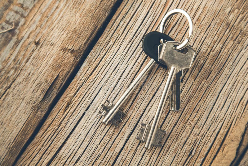Keys on the wooden desk. stock photo. Image of silver - 213242584