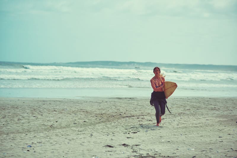 Kick Off Summer with a Surf. a Beautiful Young Woman Going for a Surf ...