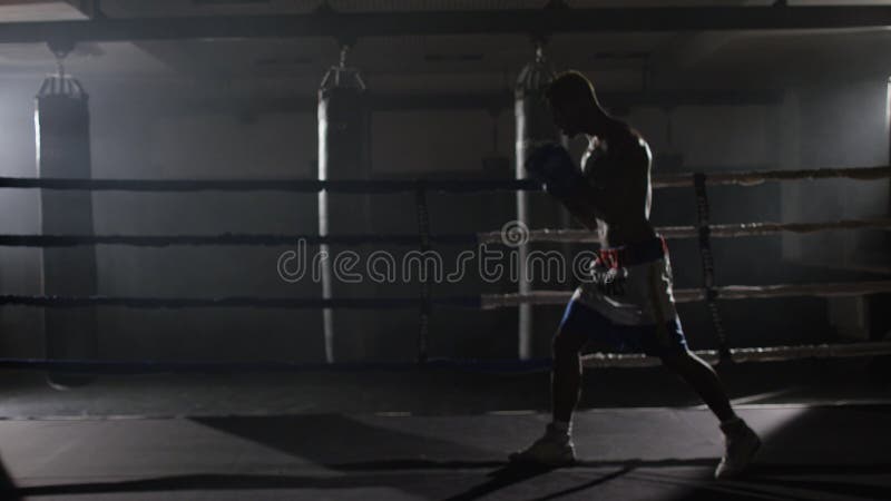 Kickbox Fighter Shadow Boxing in the Ring. the Athlete Fights with His ...