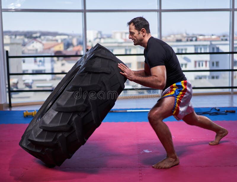 Kickboxer Doing Tire Flips in the Gym Stock Photo - Image of action ...