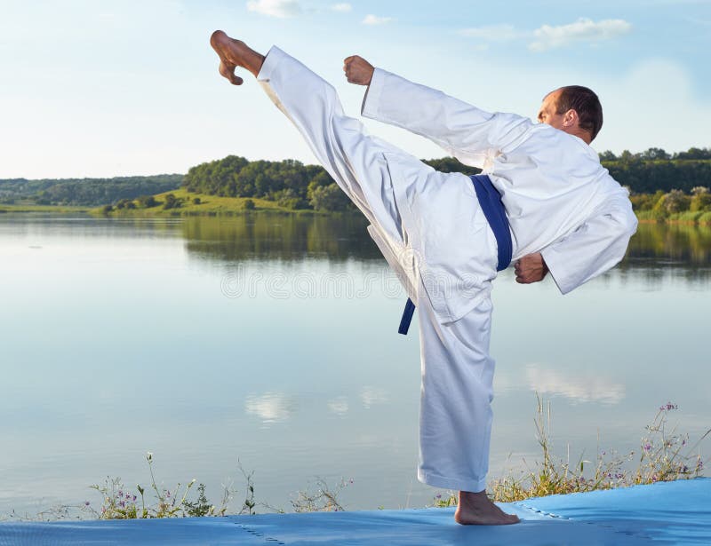 Kicking is Beating Athlete on a Blue Mats Stock Photo - Image of ...