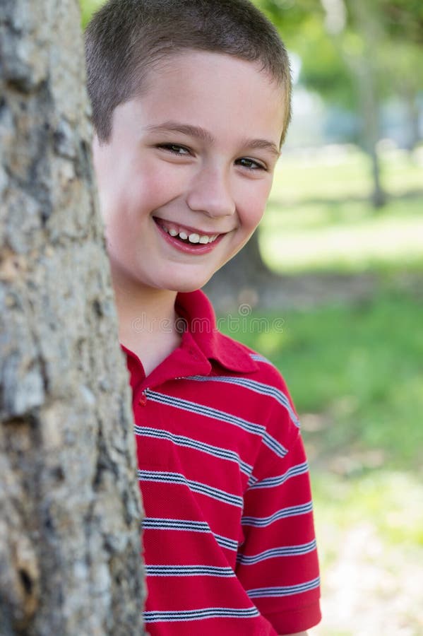 Kid Behind a Tree in a Park Stock Photo - Image of green, years: 25148540