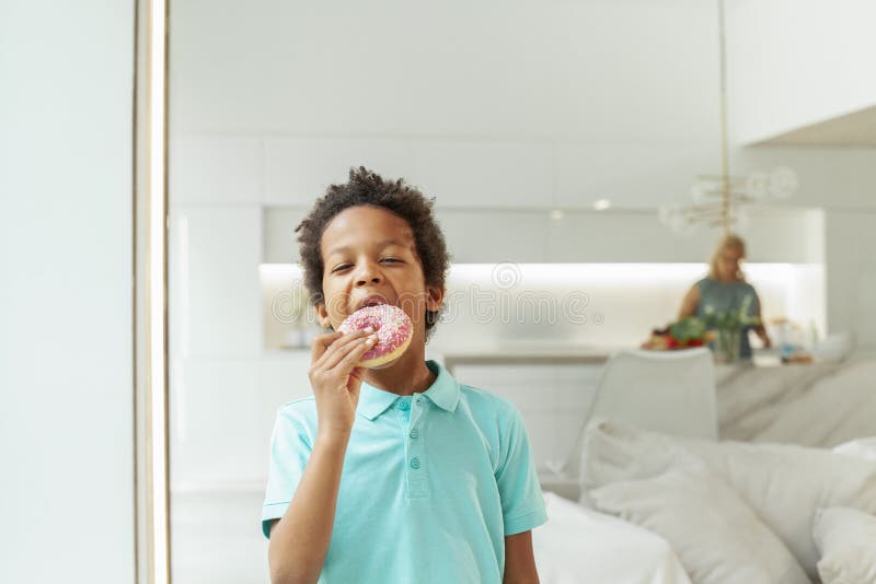 Kid Boy with Black Hair Eating Donut at Home Stock Photo - Image of ...