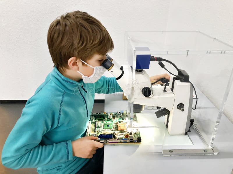 Kid Boy Conducts Experiment with Microscope in School Lab. Curious ...
