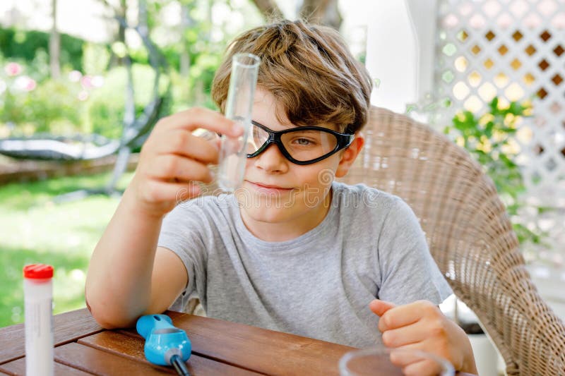 Kid Boy Doing Chemical Experiment in Laboratory at School. Child with ...